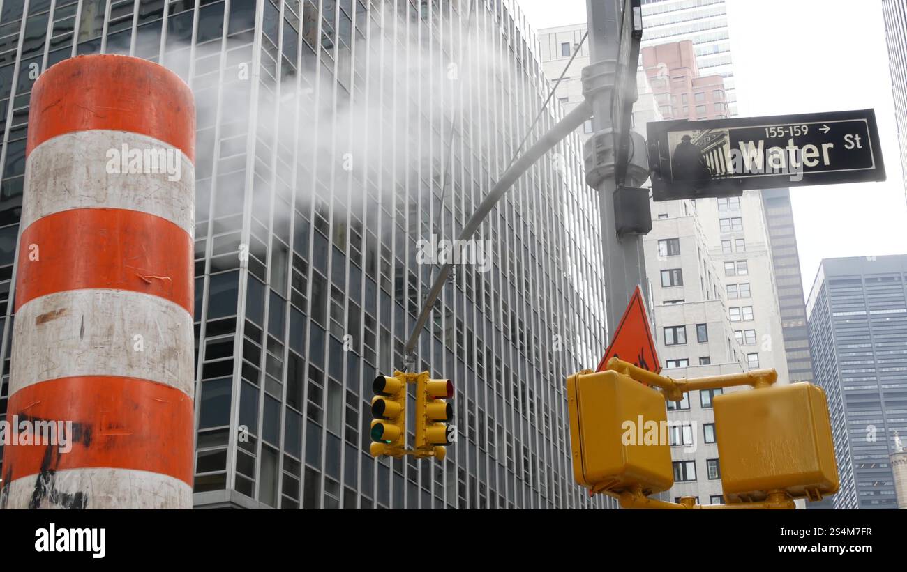 Steam vapor vented on New York City Water street, orange vapour tube ...