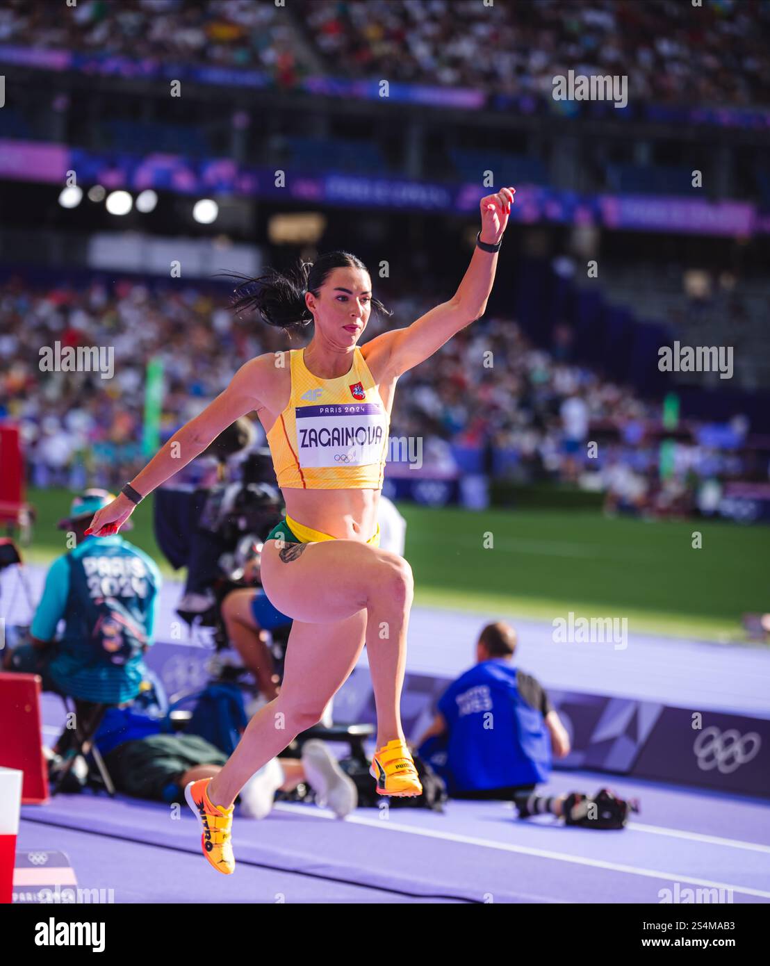Diana Zagainova celebrating her medal with her country's flag at the ...