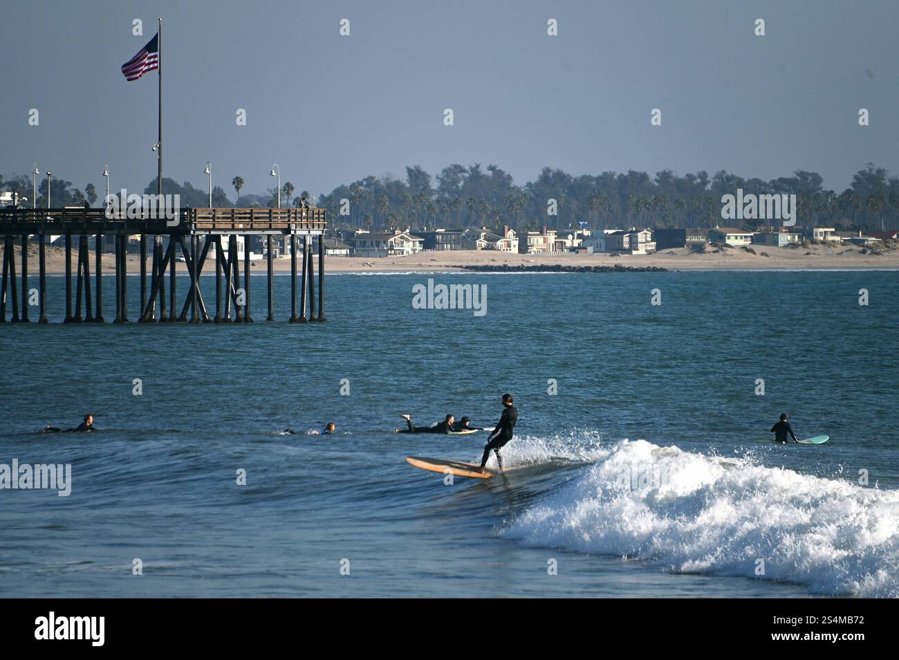 Surfers in the Pacific Ocean, on the beach in Ventura, California, USA ...