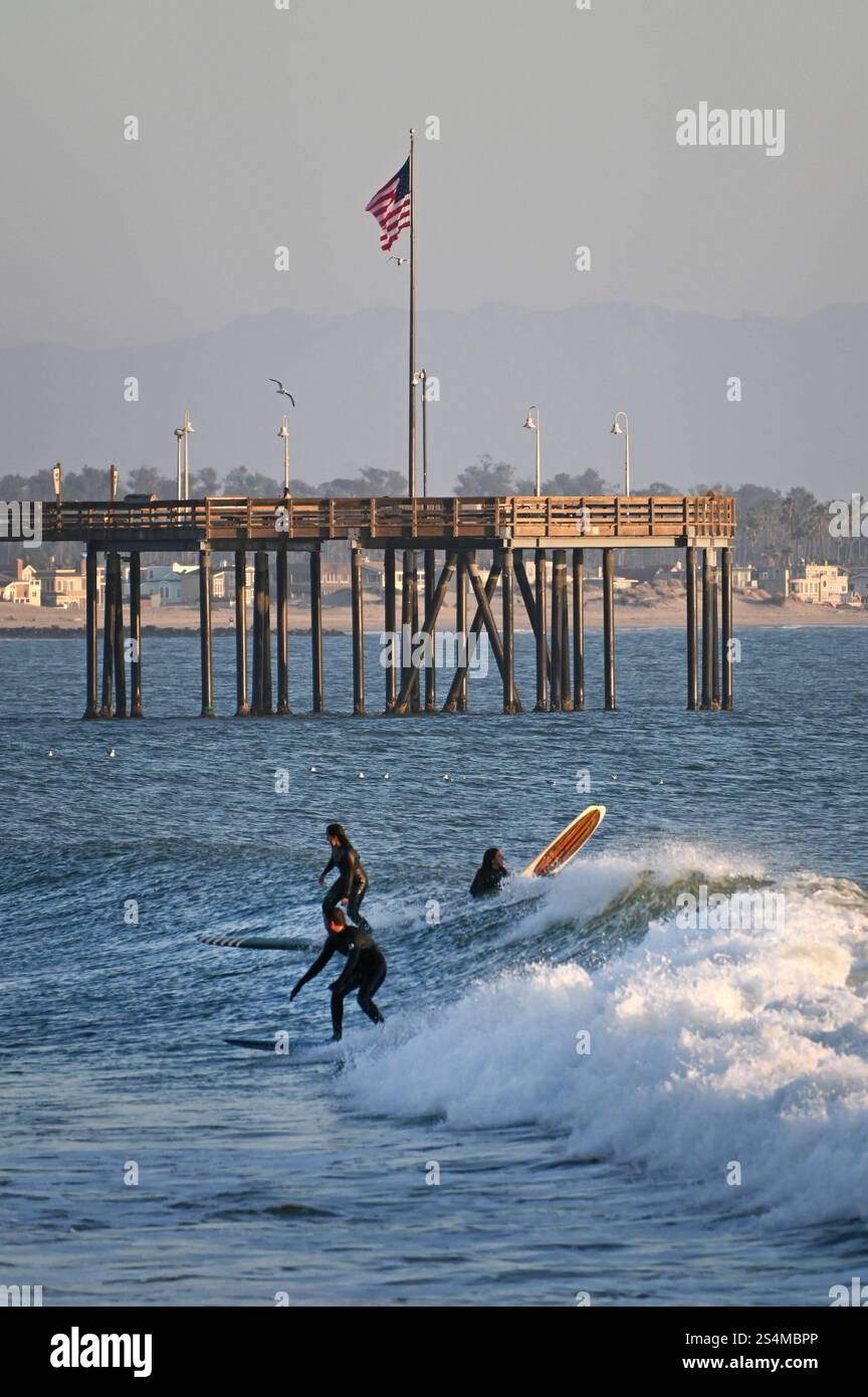 Surfers in the Pacific Ocean, on the beach in Ventura, California, USA ...