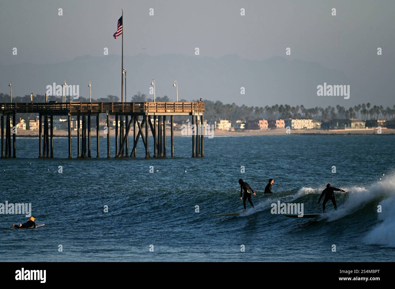 Surfers in the Pacific Ocean, on the beach in Ventura, California, USA ...