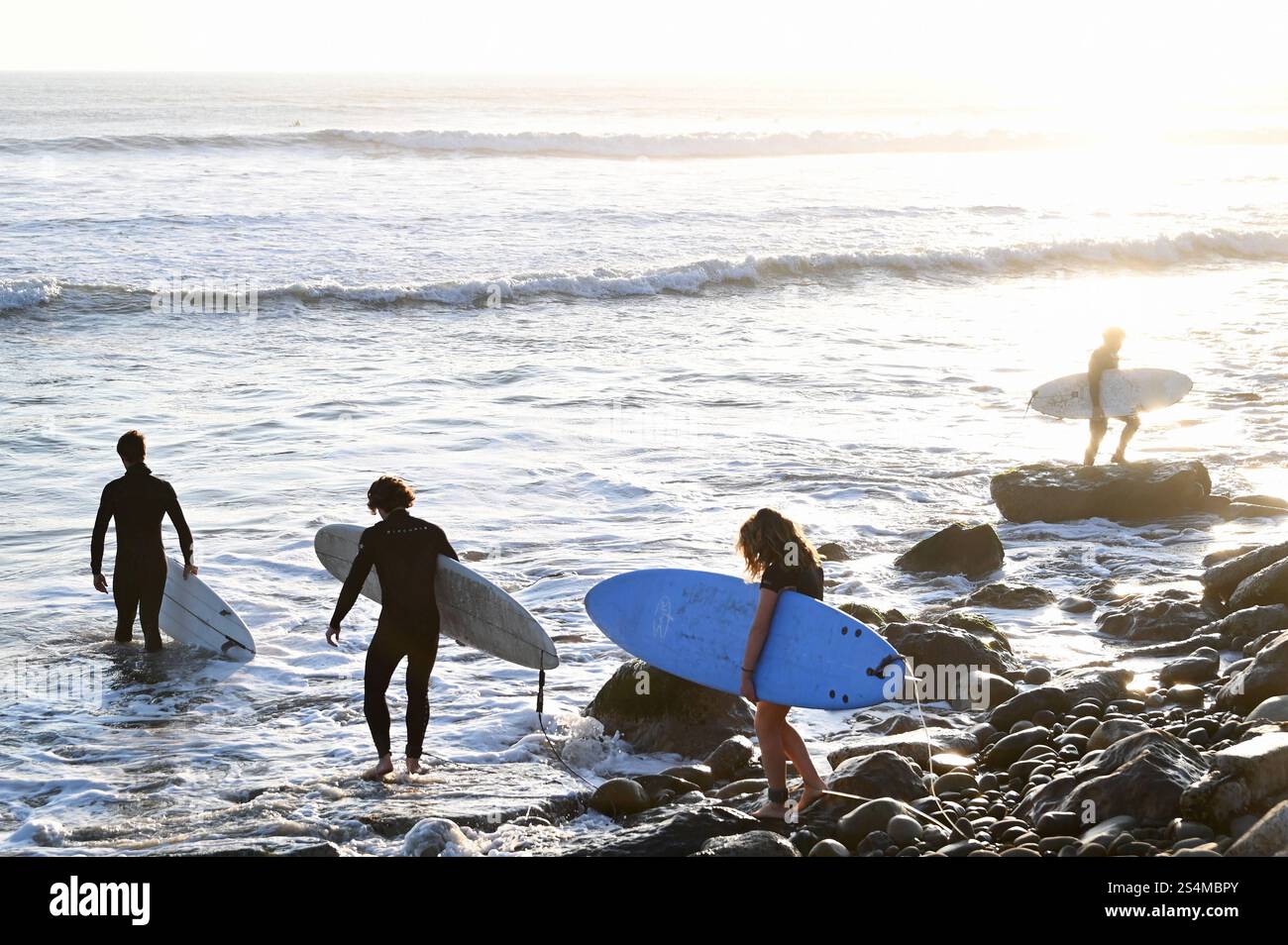 Surfers in the Pacific Ocean, on the beach in Ventura, California, USA ...