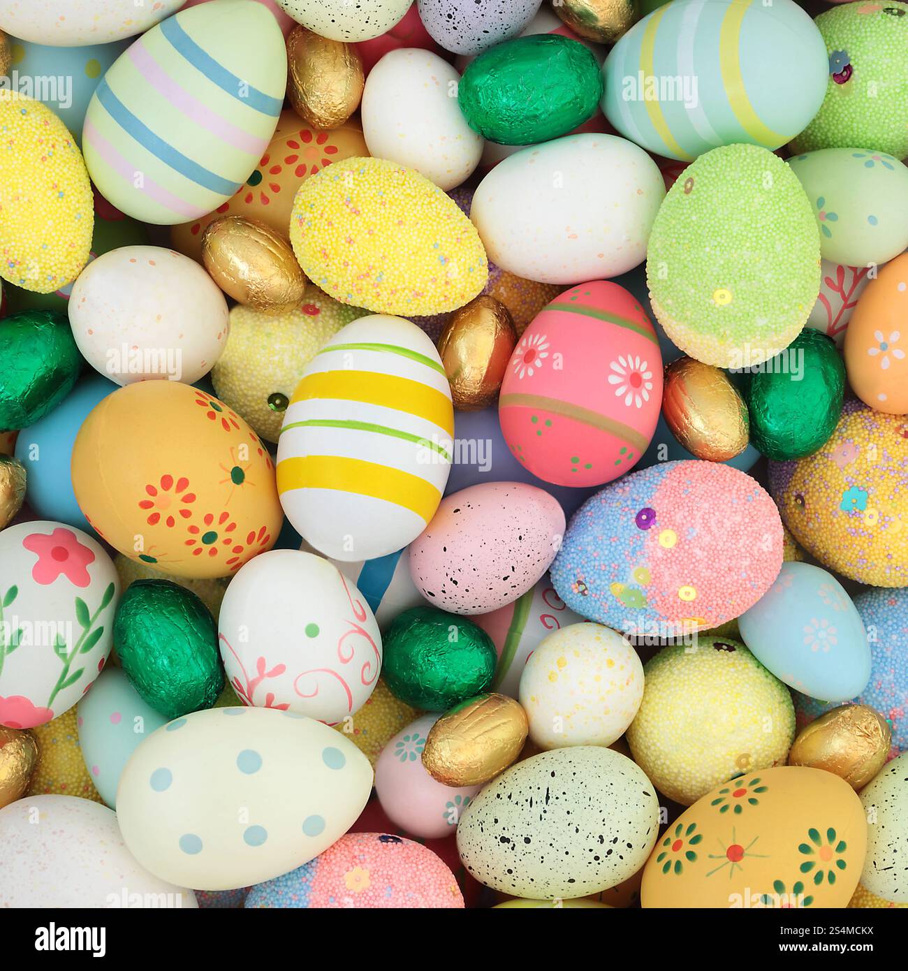 Symbols of Easter background with decorated and foil wrapped eggs ...