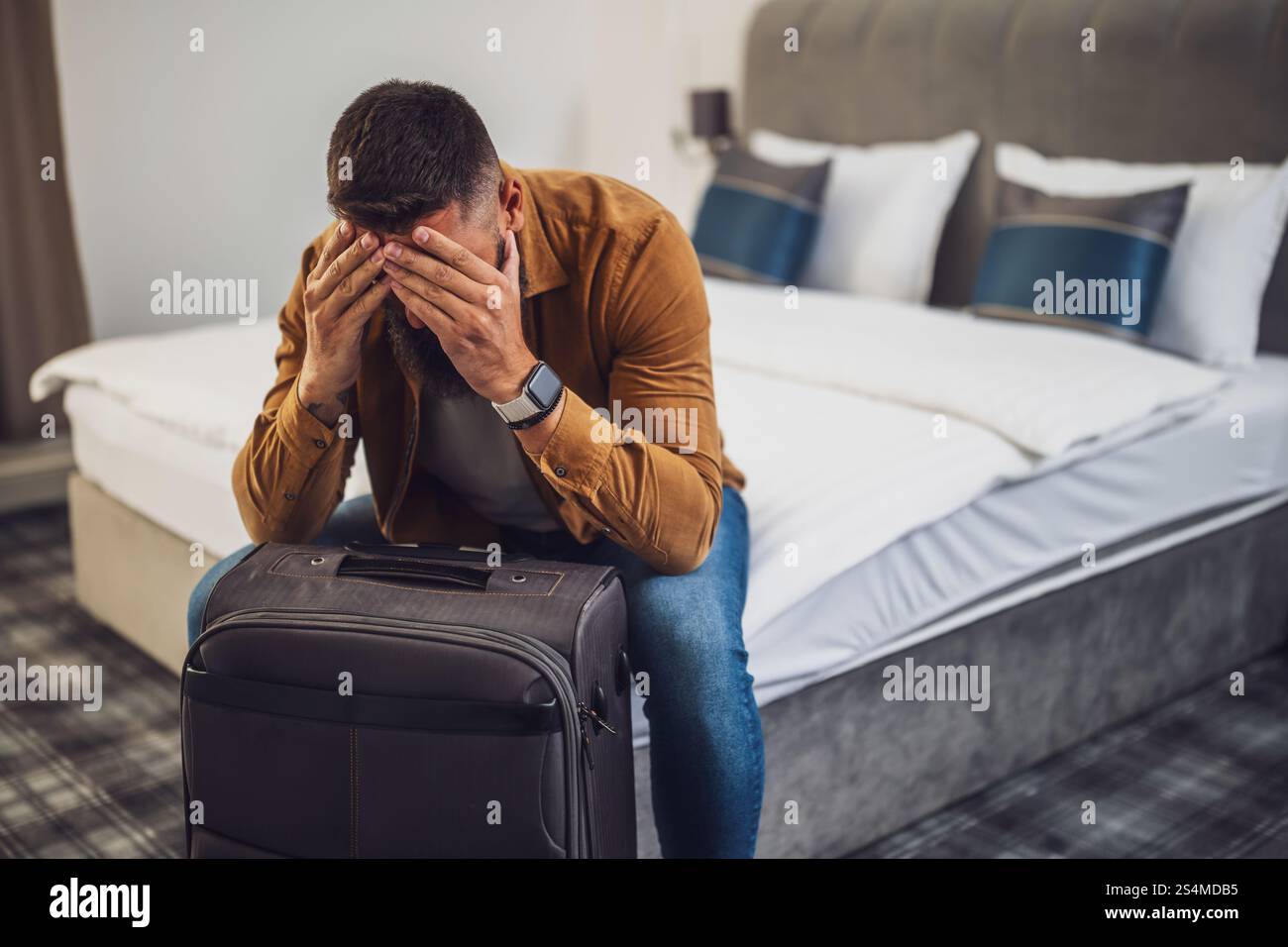 Tourist arrived in hotel room with her suitcase. He is tired of travel ...