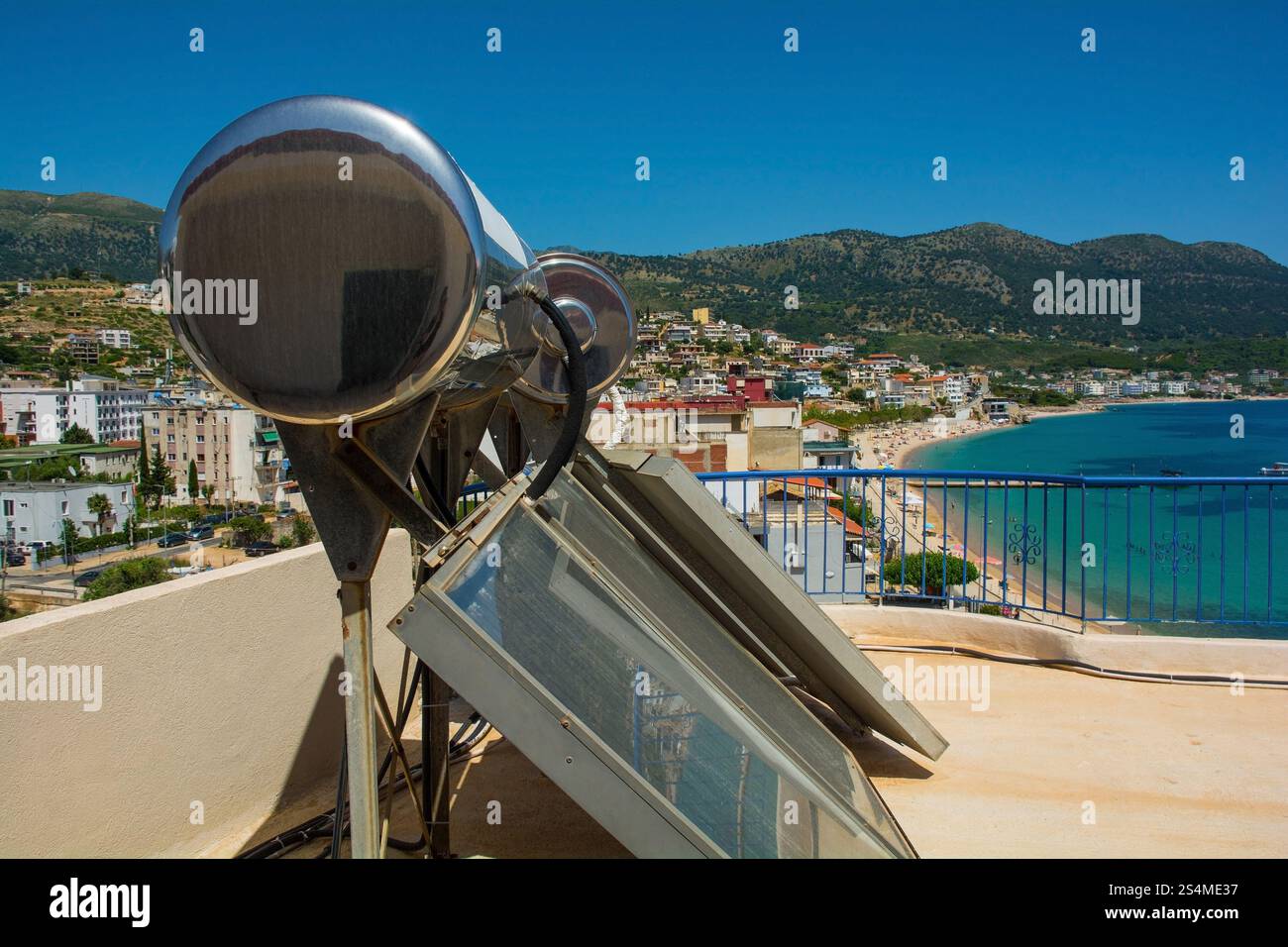 A solar powered water heating tank on the flat rooftop of an apartment ...