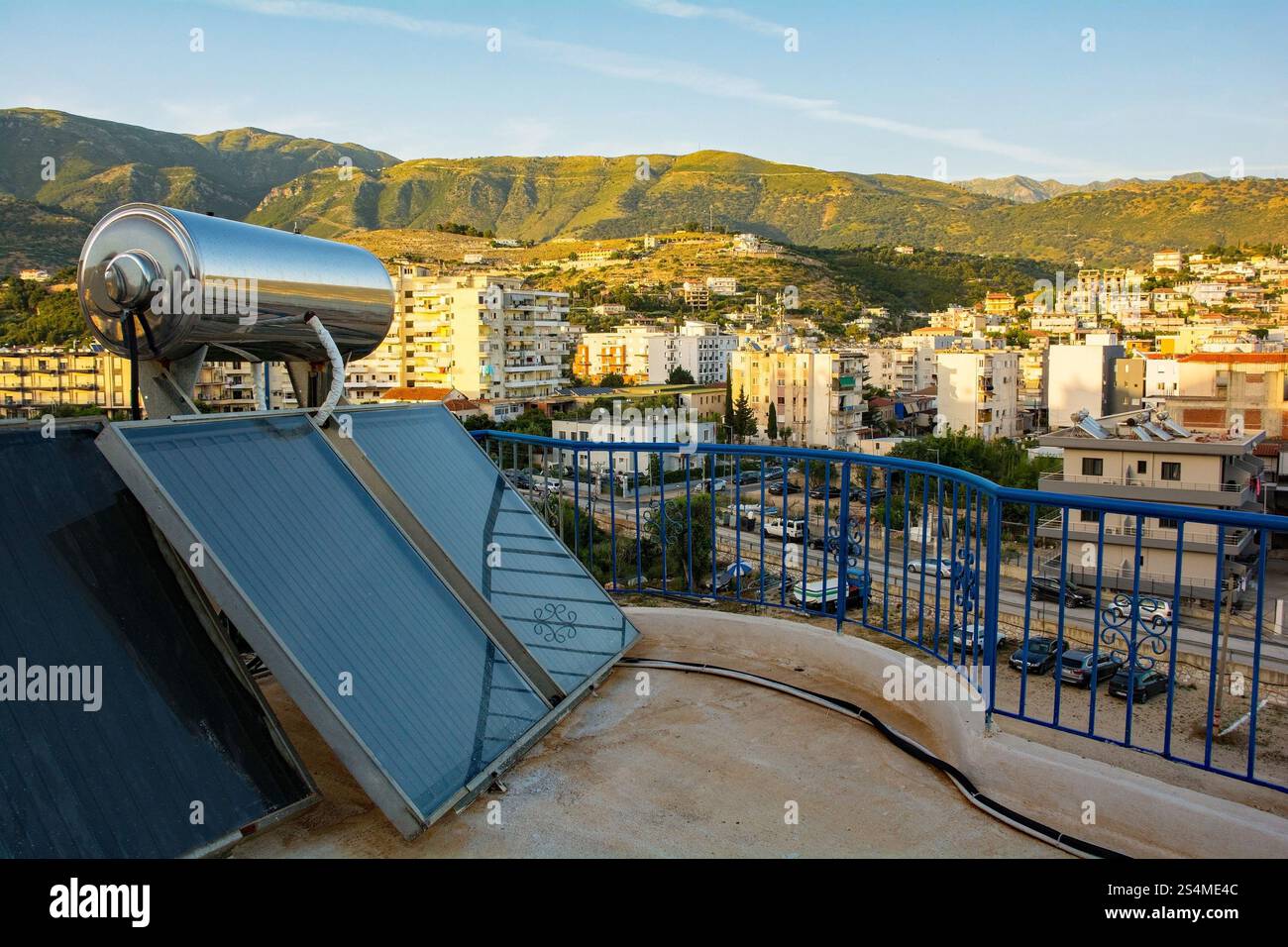 A solar powered water heating tank on the flat rooftop of an apartment ...