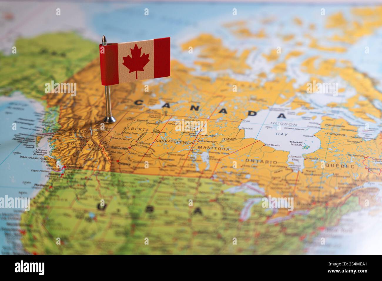 A Canadian flag pinpointed on a map of Canada, symbolizing national ...