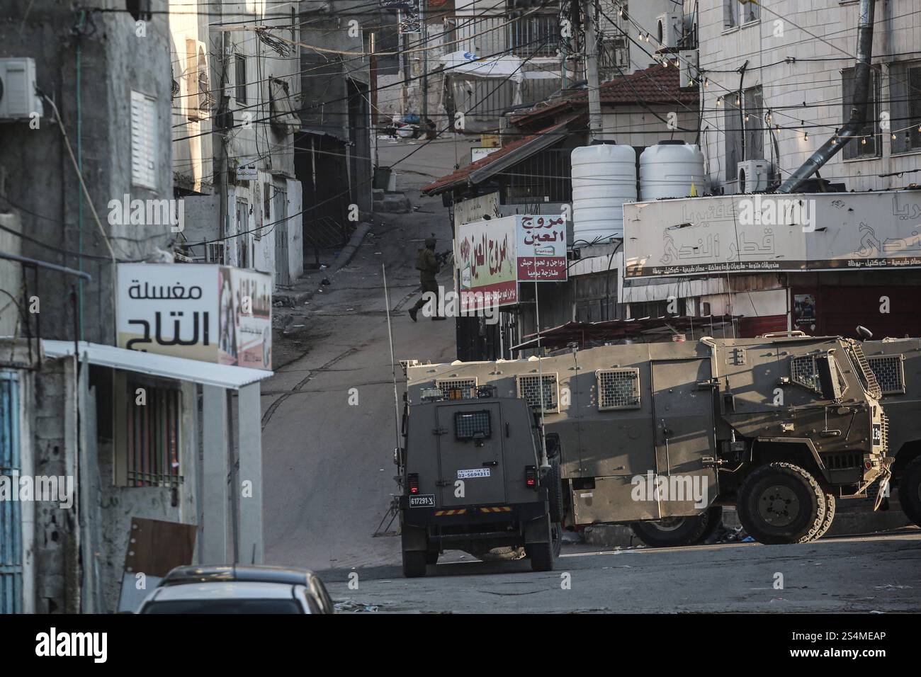 Israeli military vehicles are seen during a raid on the Ein Beit al-Maa ...