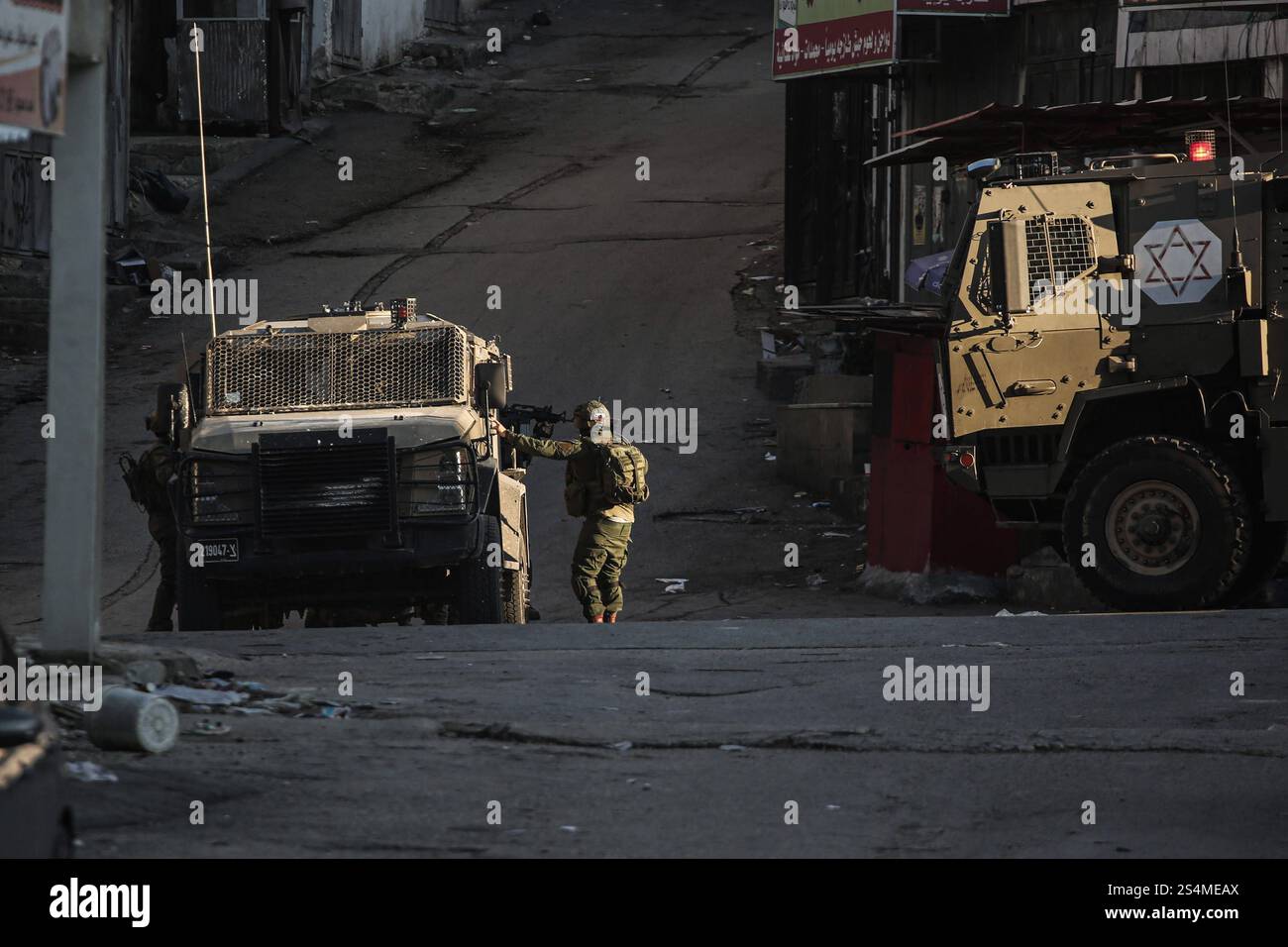 Israeli military vehicles are seen during a raid on the Ein Beit al-Maa ...