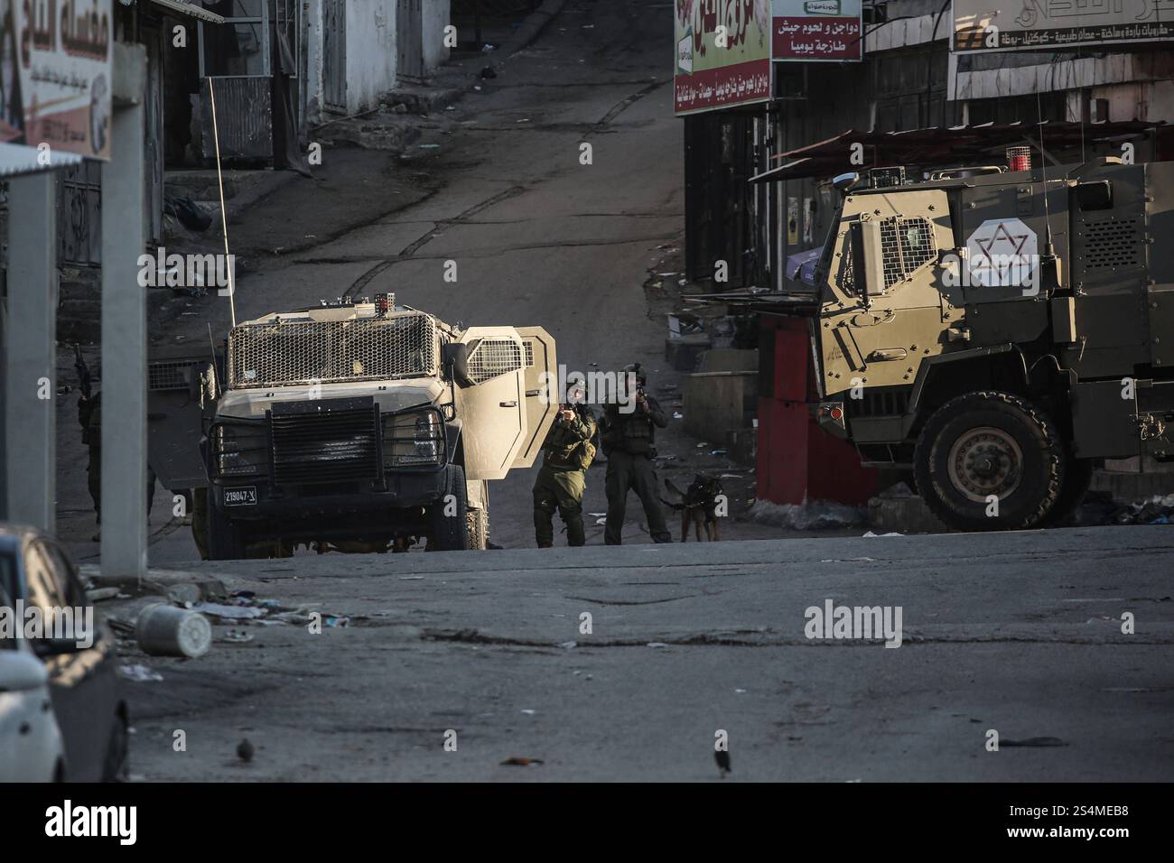 Israeli military vehicles are seen during a raid on the Ein Beit al-Maa ...