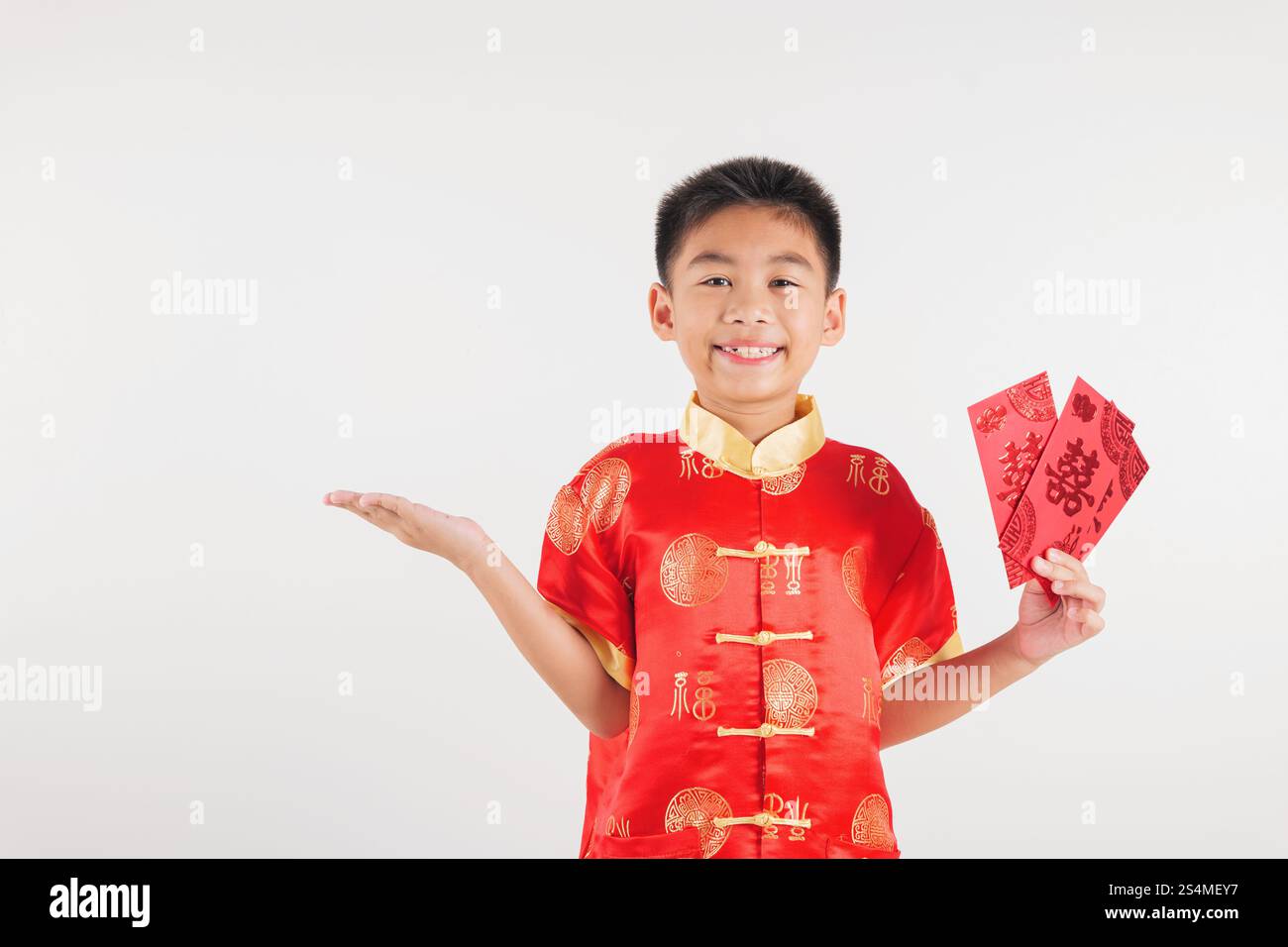 Chinese New Year celebration. Smiling Asian boy in a red cheongsam ...