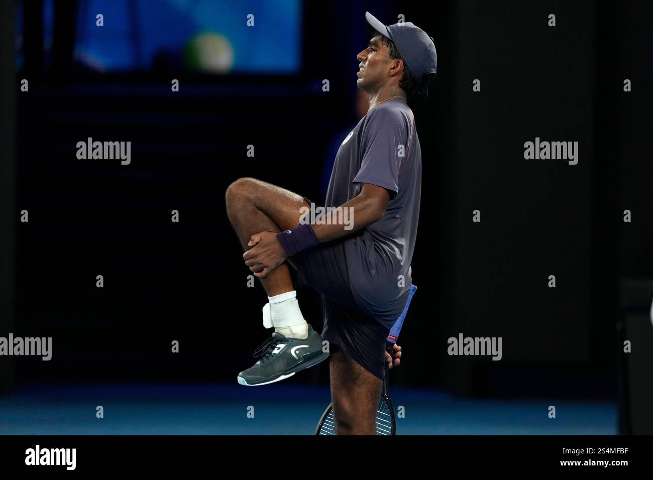 Nishesh Basavareddy of the U.S. stretches during his first round match ...