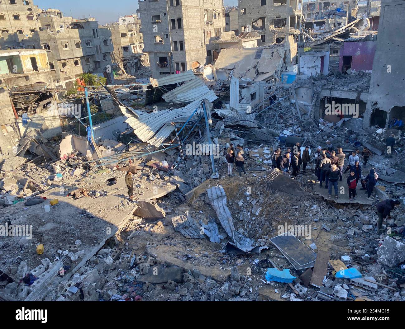People search for their belongings amid the rubble of buildings ...