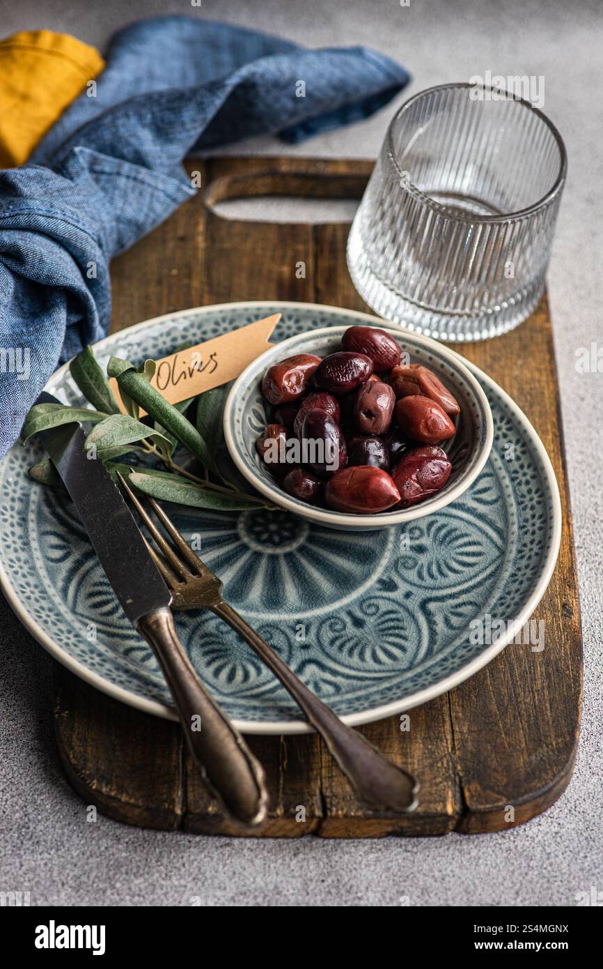 A tasteful arrangement of Greek BBQ olives on a ceramic plate ...