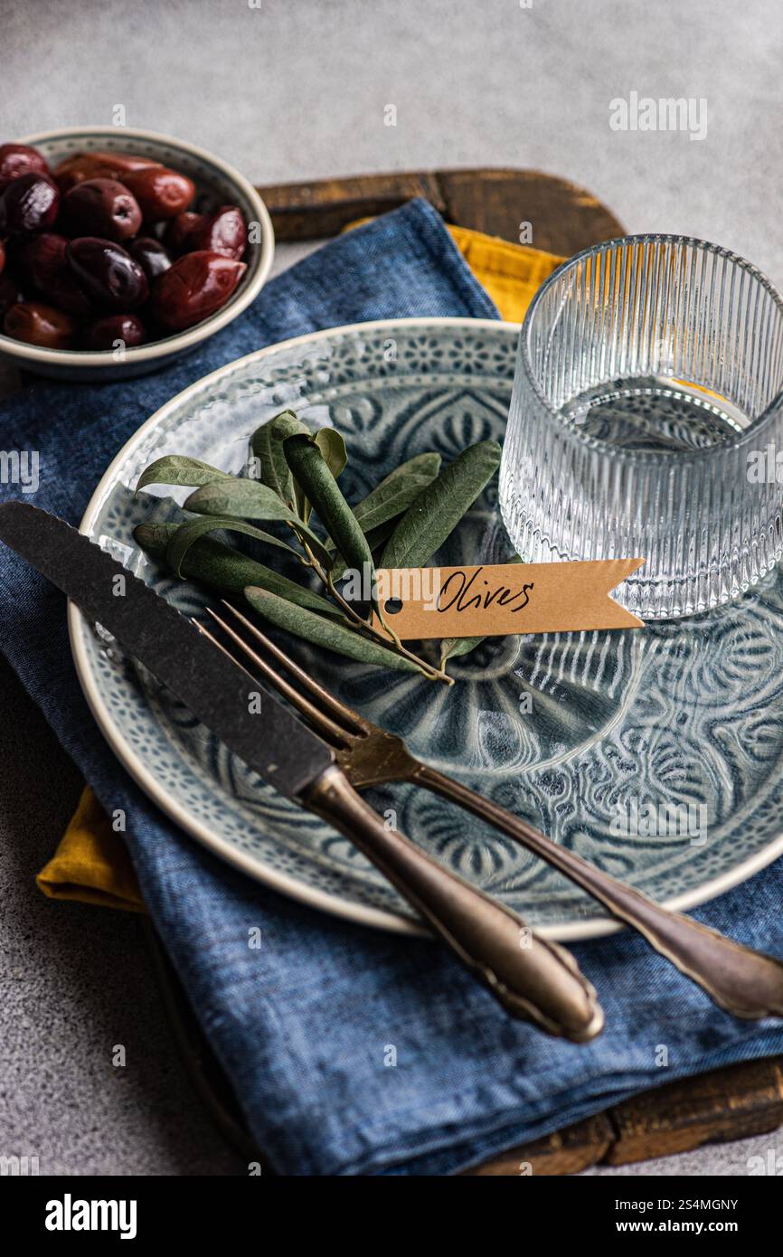 A tasteful arrangement of Greek BBQ olives on a ceramic plate ...