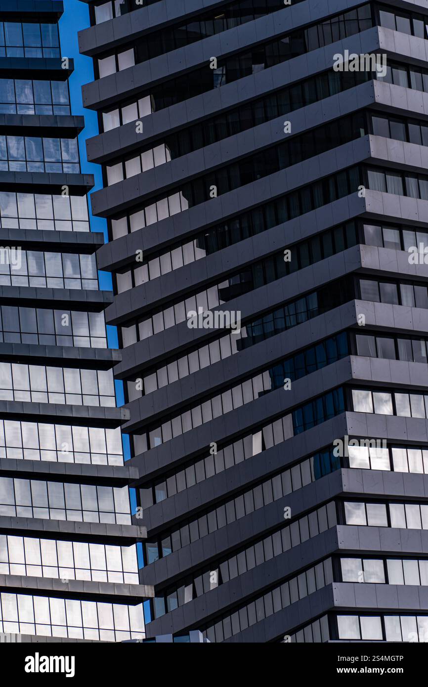 A detailed view of modern skyscraper exteriors featuring blue-tinted ...