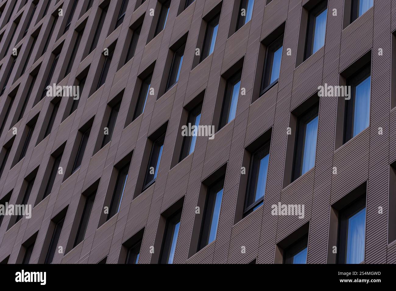 A detailed view of a modern building facade featuring a repetitive ...