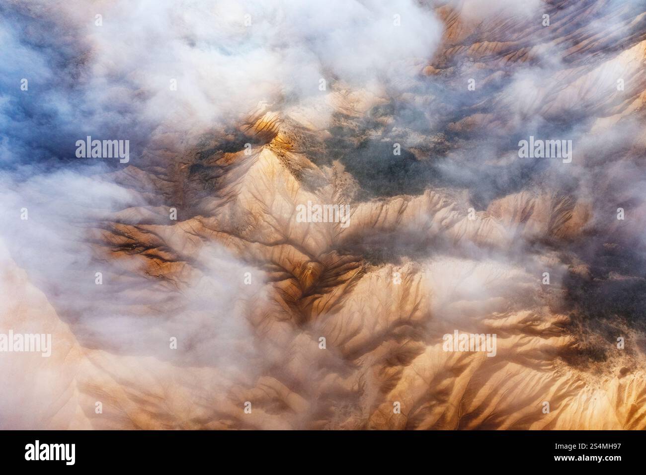 Stunning aerial view of rocky mountain peaks partially obscured by ...