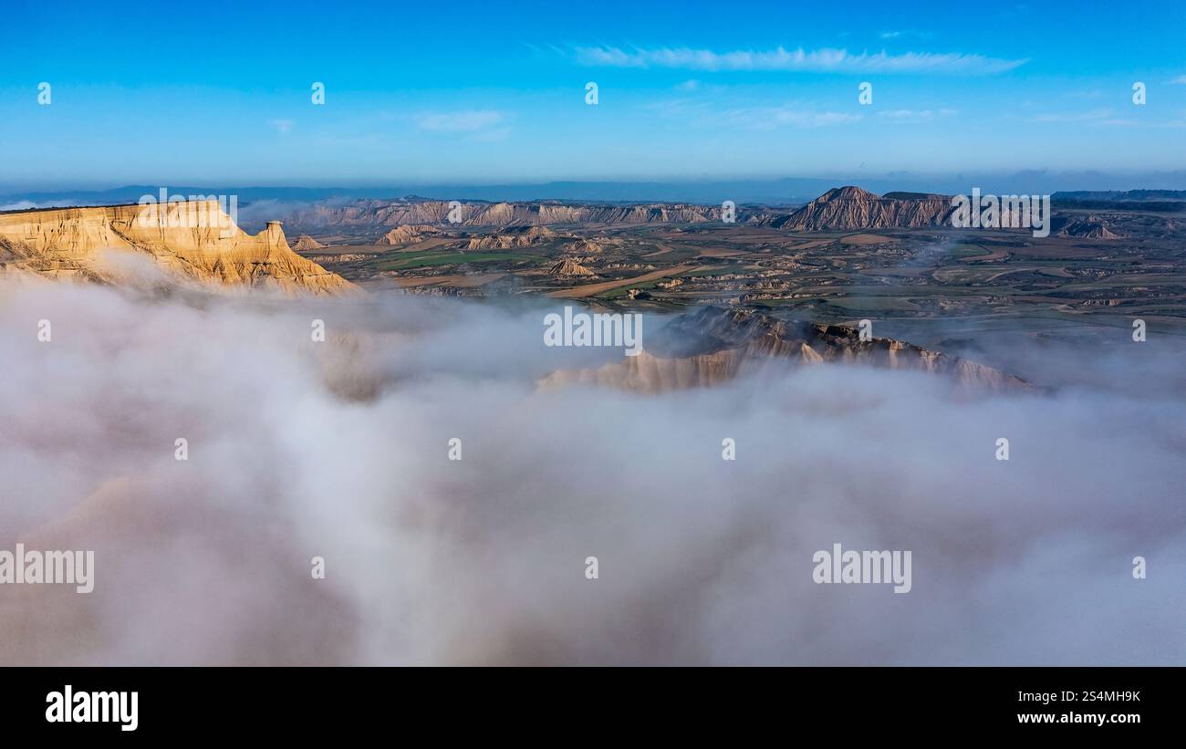A stunning view of a rugged mountain range shrouded in rolling clouds ...