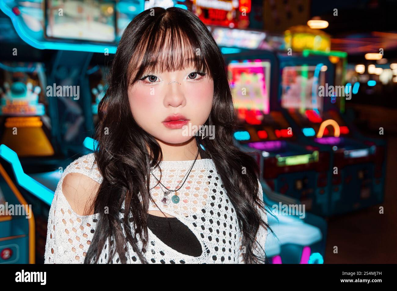 Asian Gen Z girl explores a vibrant arcade, surrounded by colorful ...