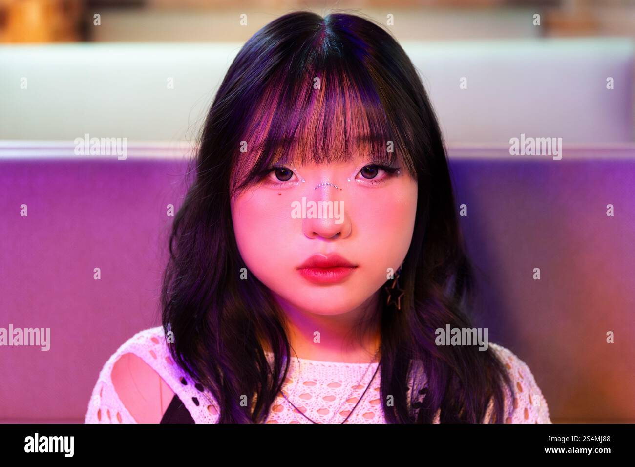 An Asian Gen Z girl is immersed in the vibrant atmosphere of an arcade ...