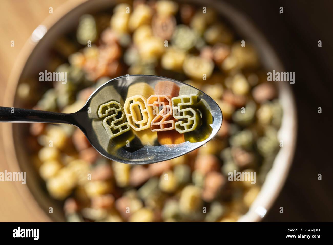 A spoonful of numerically shaped pasta displays the year 2025 above a ...