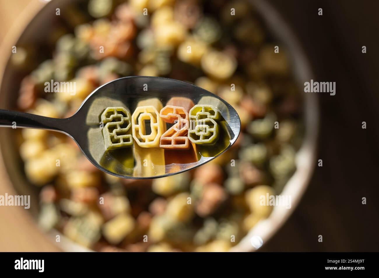 A spoonful of numerically shaped pasta displays the year 2026 above a ...