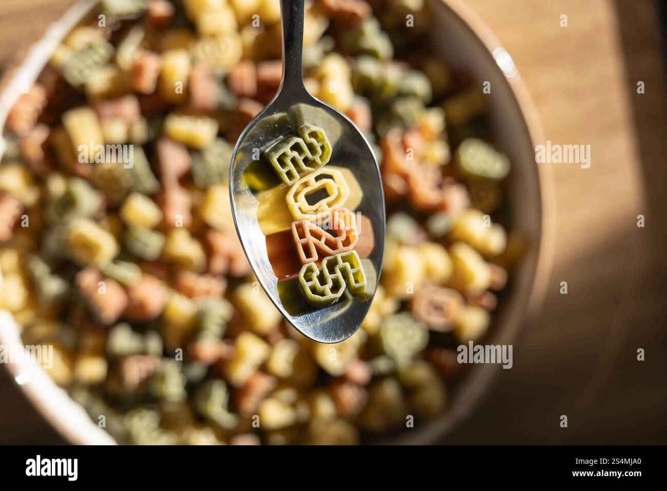 A spoonful of numerically shaped pasta displays the year 2025 above a ...