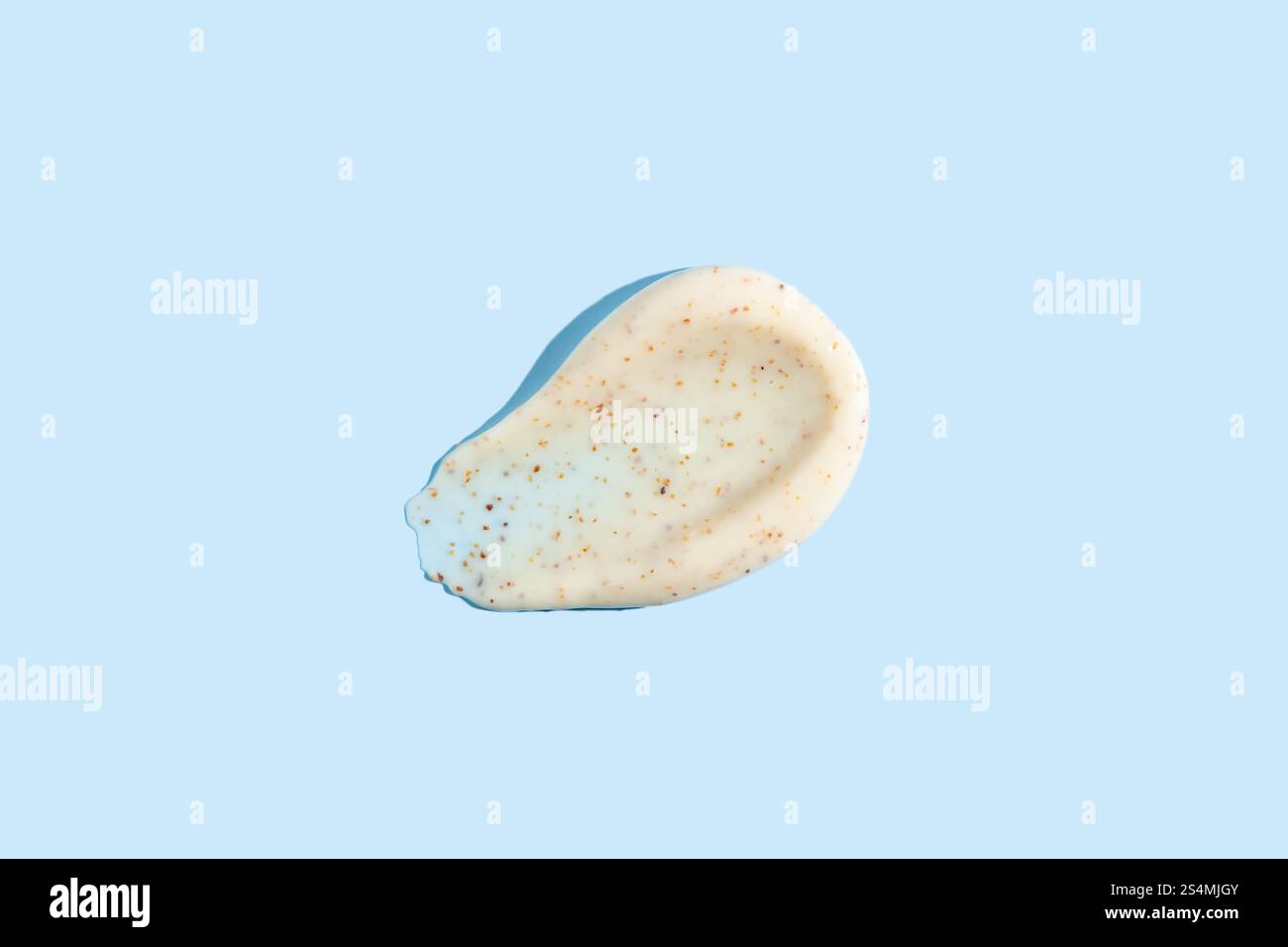 A dab of exfoliating cream with visible scrub particles smeared on a ...