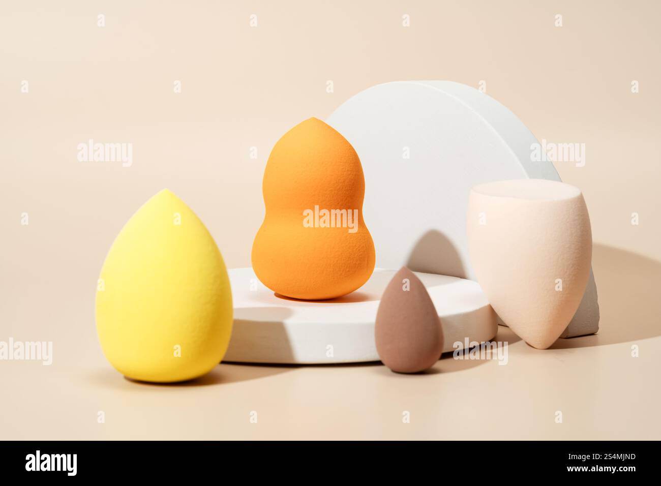 A variety of colorful cosmetic sponges in different shapes and sizes on ...