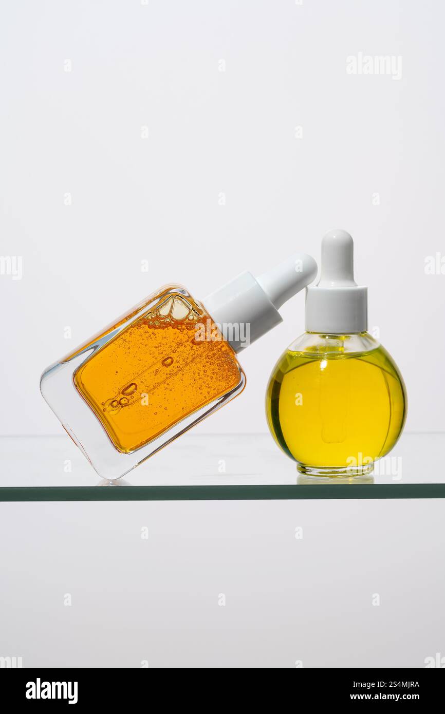Two elegant pipette bottles filled with vitamin C serum are showcased ...