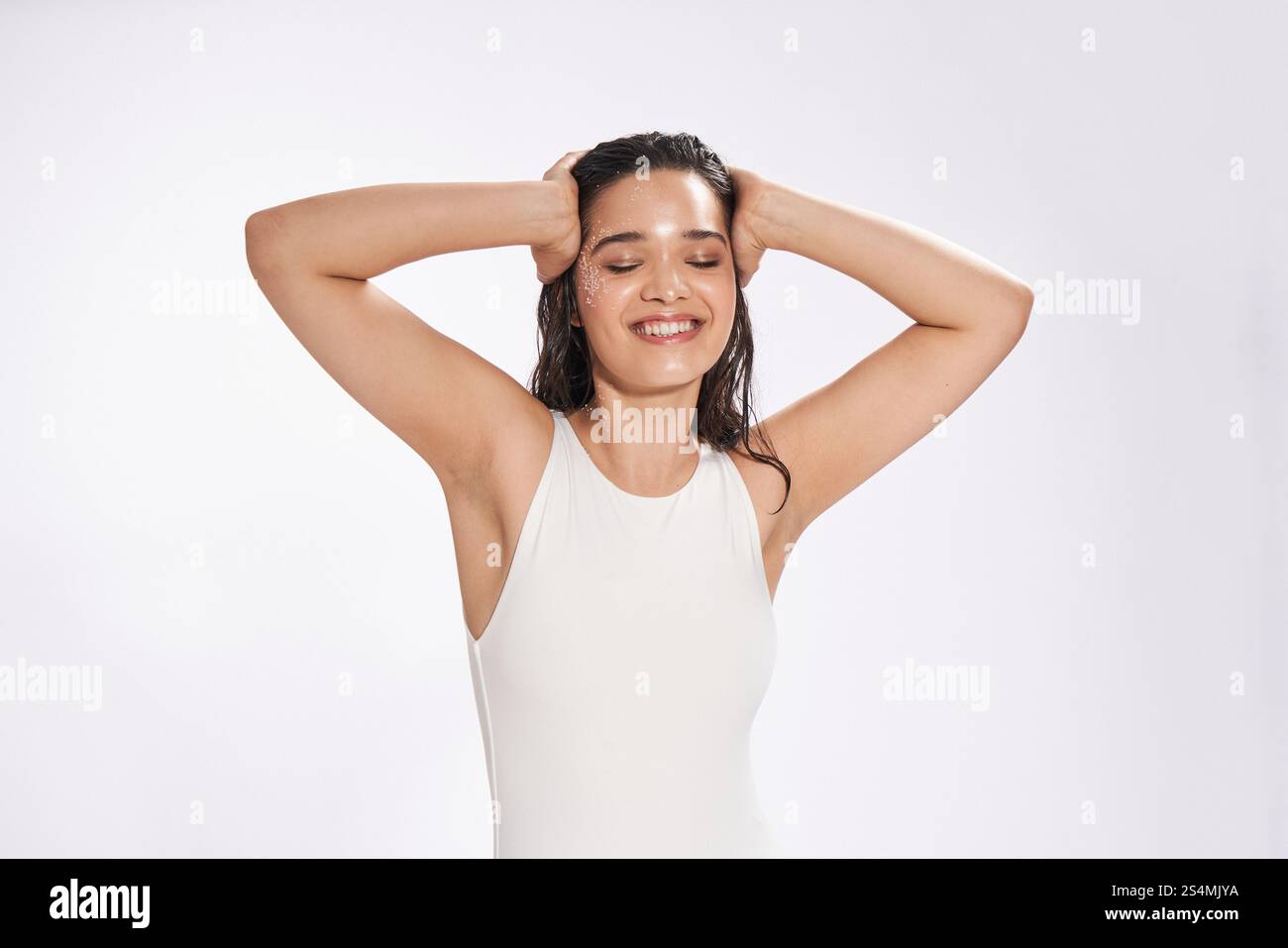 Young female model enjoying a photoshoot in a studio setting, arms ...
