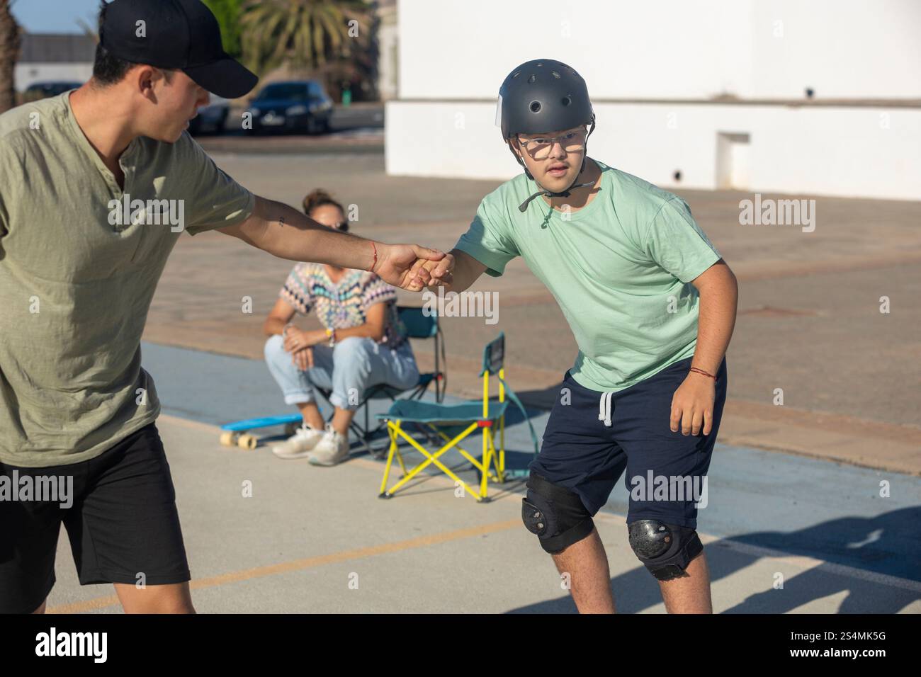 A Down syndrome teenager participates in outdoor sports, supported by ...
