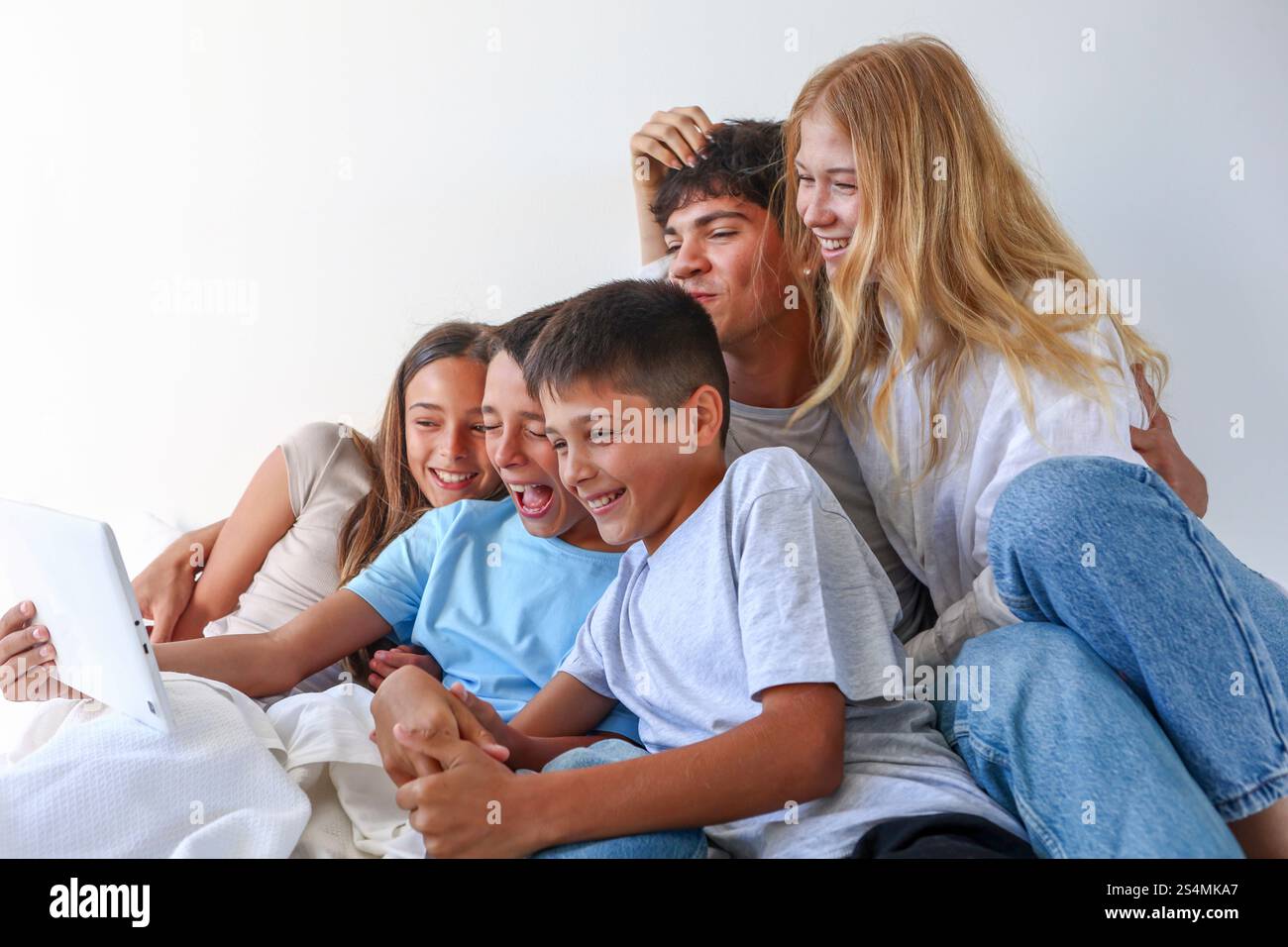 A joyful moment at home with five siblings; an older brother and sister ...