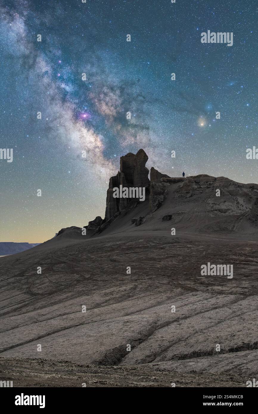 Unrecognizable person silhouette stands on a rugged Utah desert terrain ...