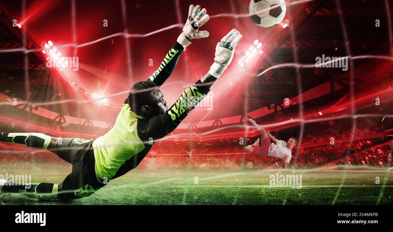 Goalkeeper in vibrant neon uniform diving mid-air to block powerful ...