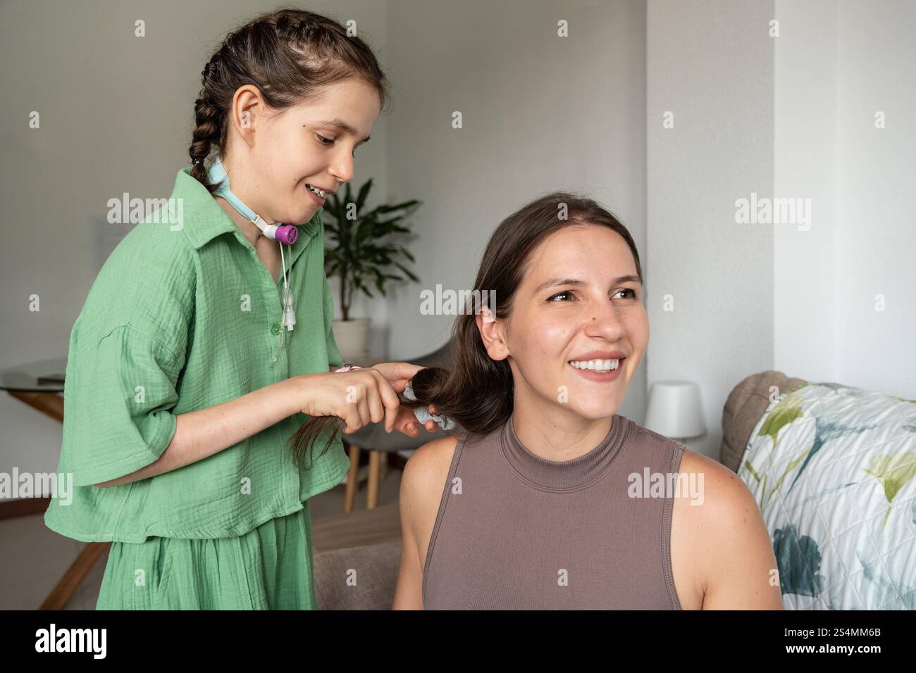 A joyful family moment with a disabled girl who has a tracheostomy. She ...
