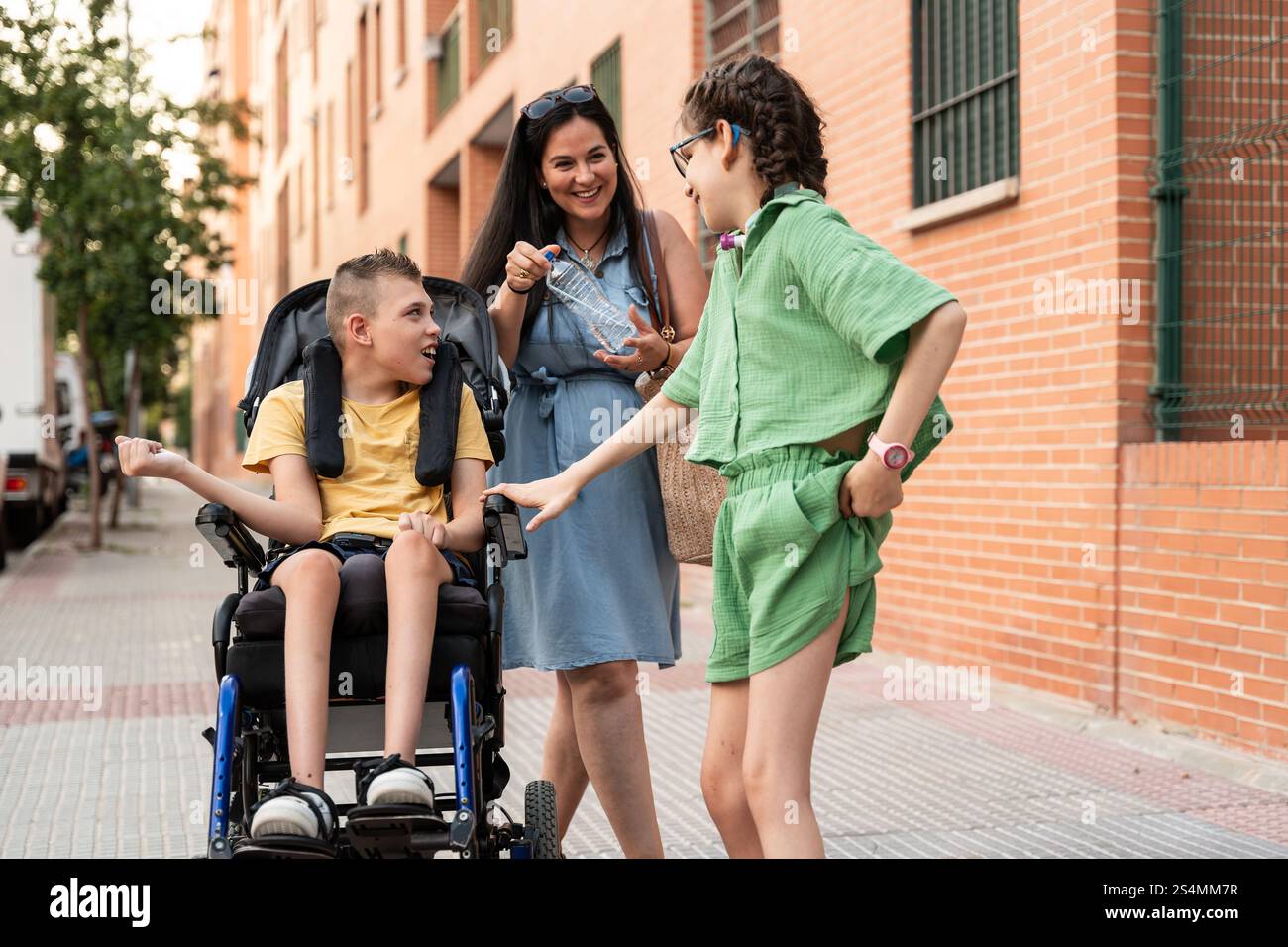 A family shares a joyful moment outdoors with a girl with a ...