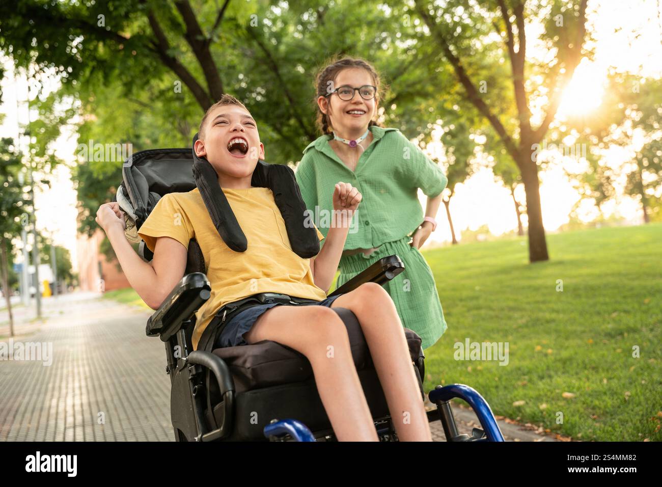 A boy with cerebral palsy in a wheelchair and a girl with a ...