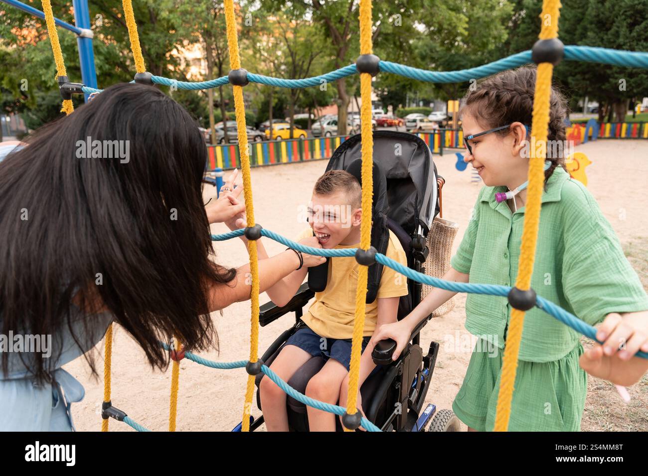 A joyful family moment at a colorful playground, featuring a girl with ...