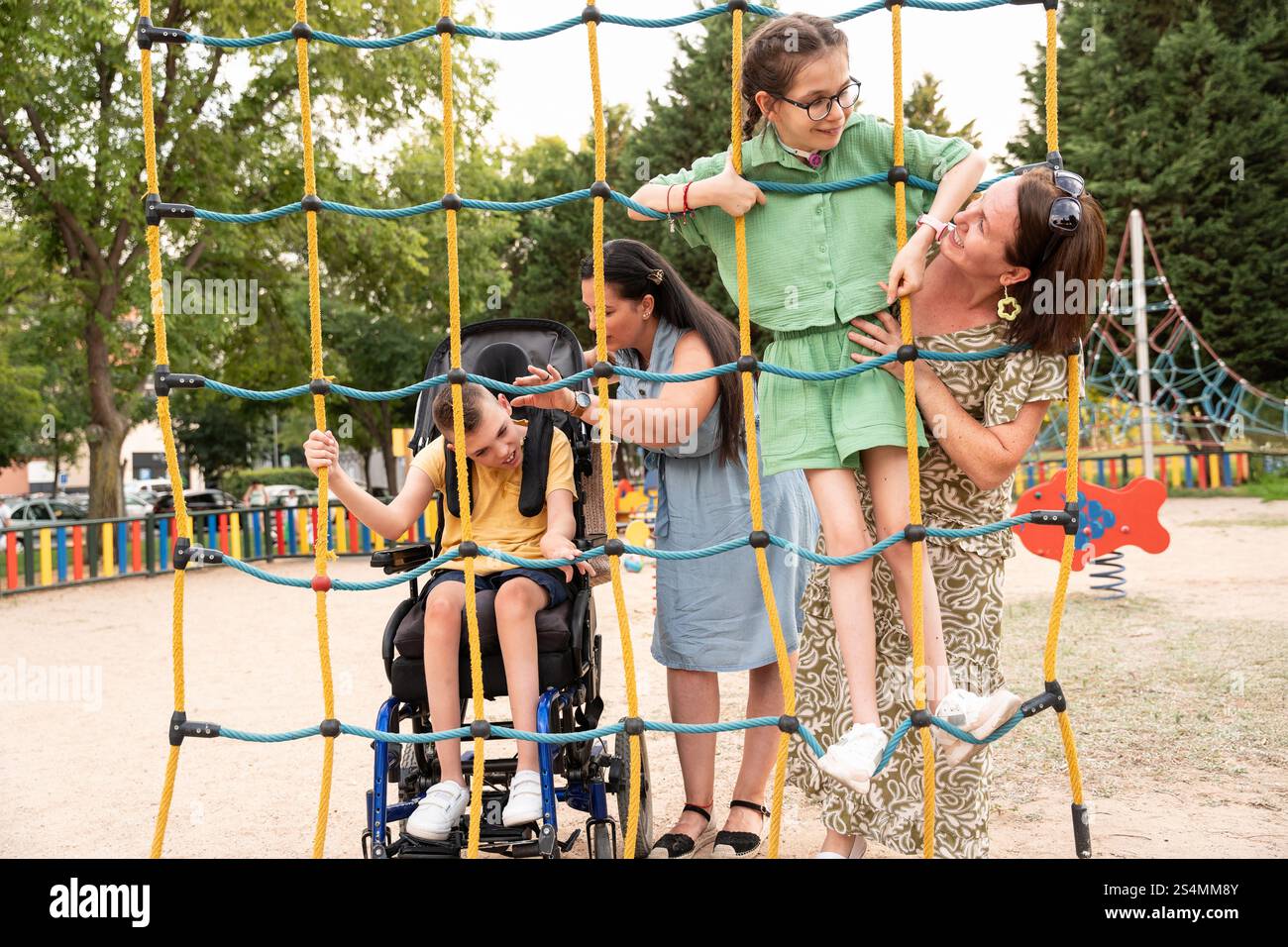 A family at the park, featuring a girl with a tracheostomy and a boy ...