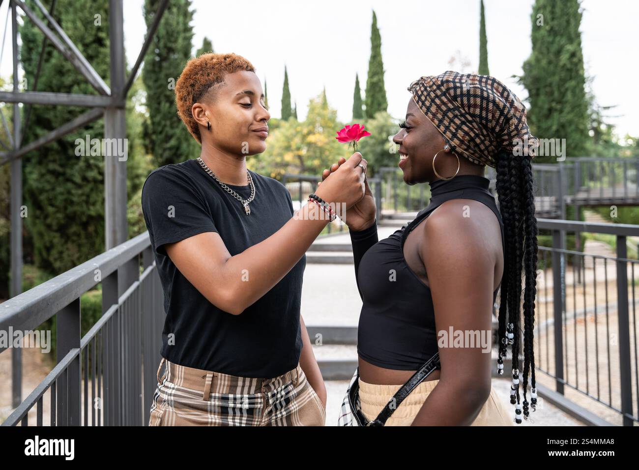 An LGBT multiethnic couple shares a tender moment in a serene park ...