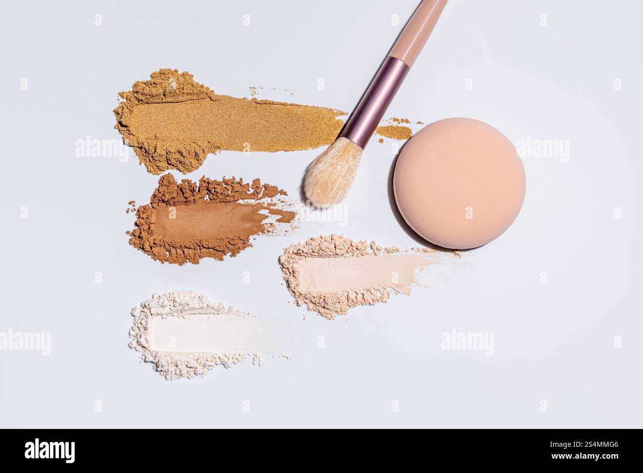 Top view of colorful, assorted face powders and a cosmetic brush on a ...