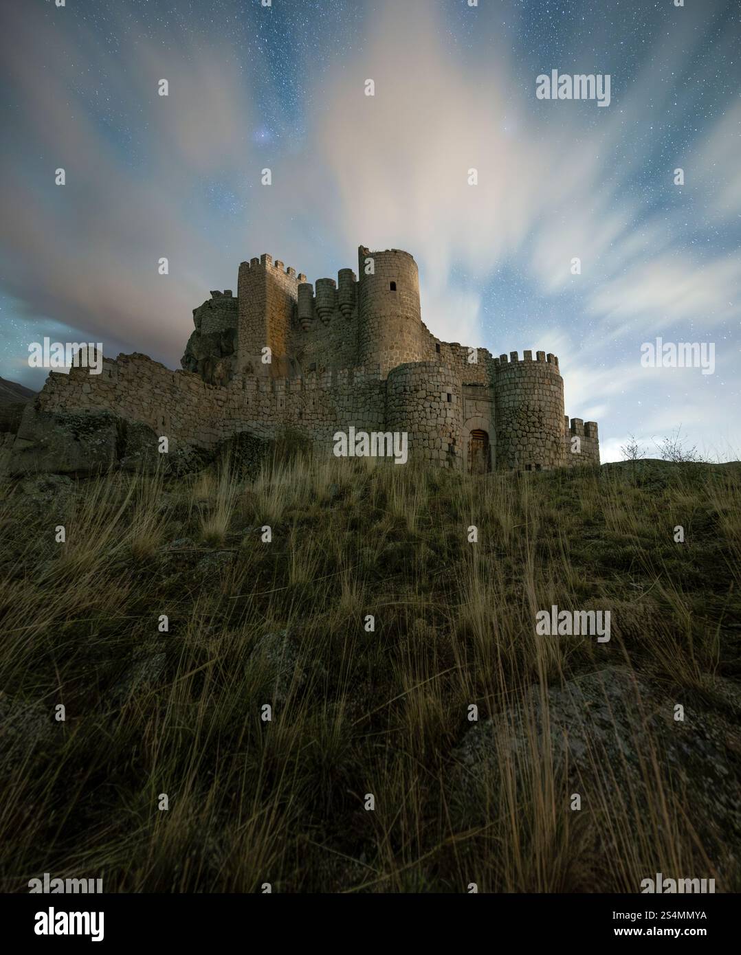 Majestic night view of Manqueospese Castle in Avila, Spain, with starry ...