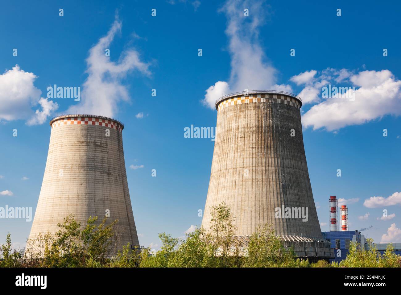 Two natural draft wet cooling towers of a power plant emitting steam ...