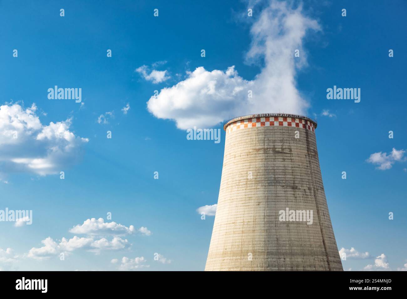 Natural draft wet cooling towers of a power plant emitting steam into a ...