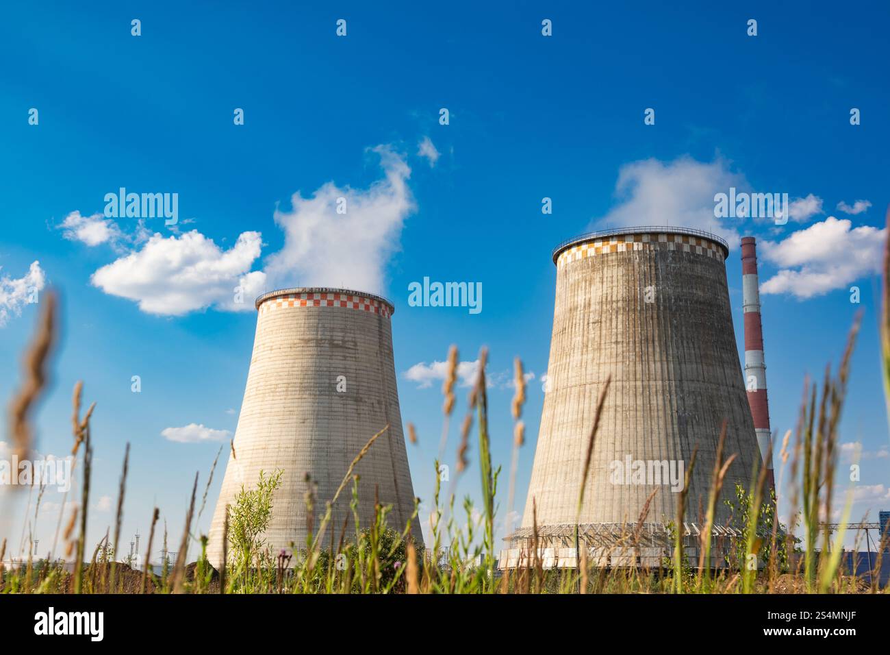 Two natural draft wet cooling towers of a power plant emitting steam ...