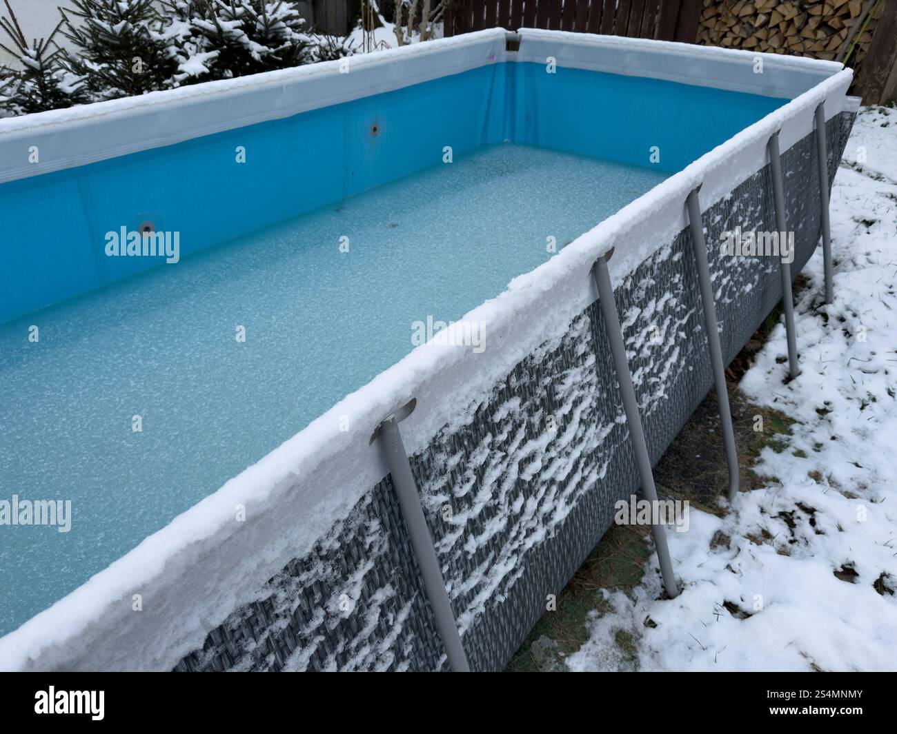Frozen swimming pool in the garden Stock Photo - Alamy