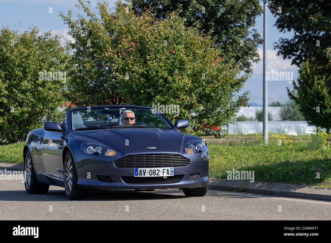 Dorlisheim, France - View on a blue Aston Martin DB9 Volante driving on ...