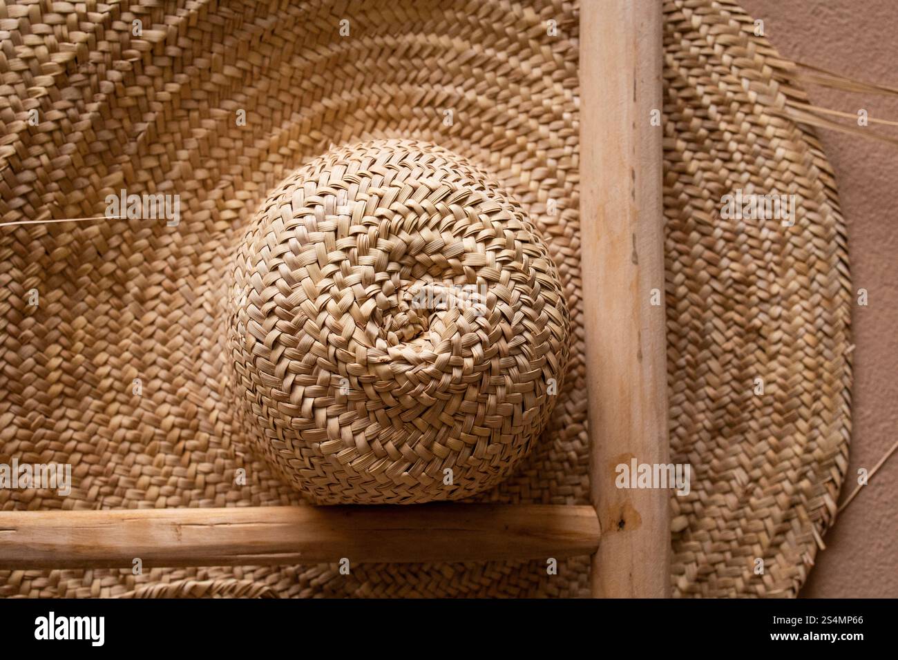 Woven straw hat and wooden ladder Stock Photo - Alamy